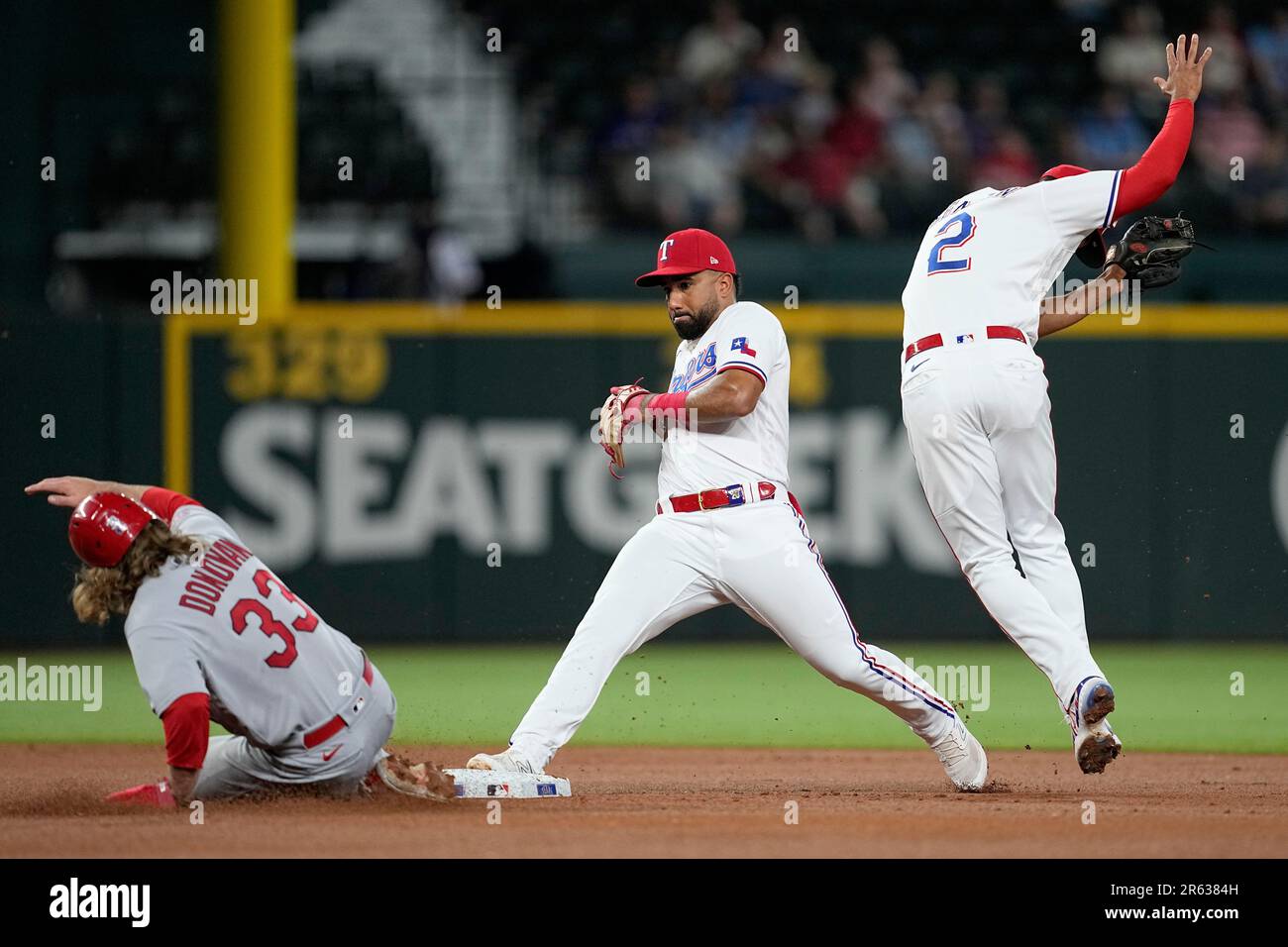 Texas Rangers shortstop Ezequiel Duran, center, steps on second to ...