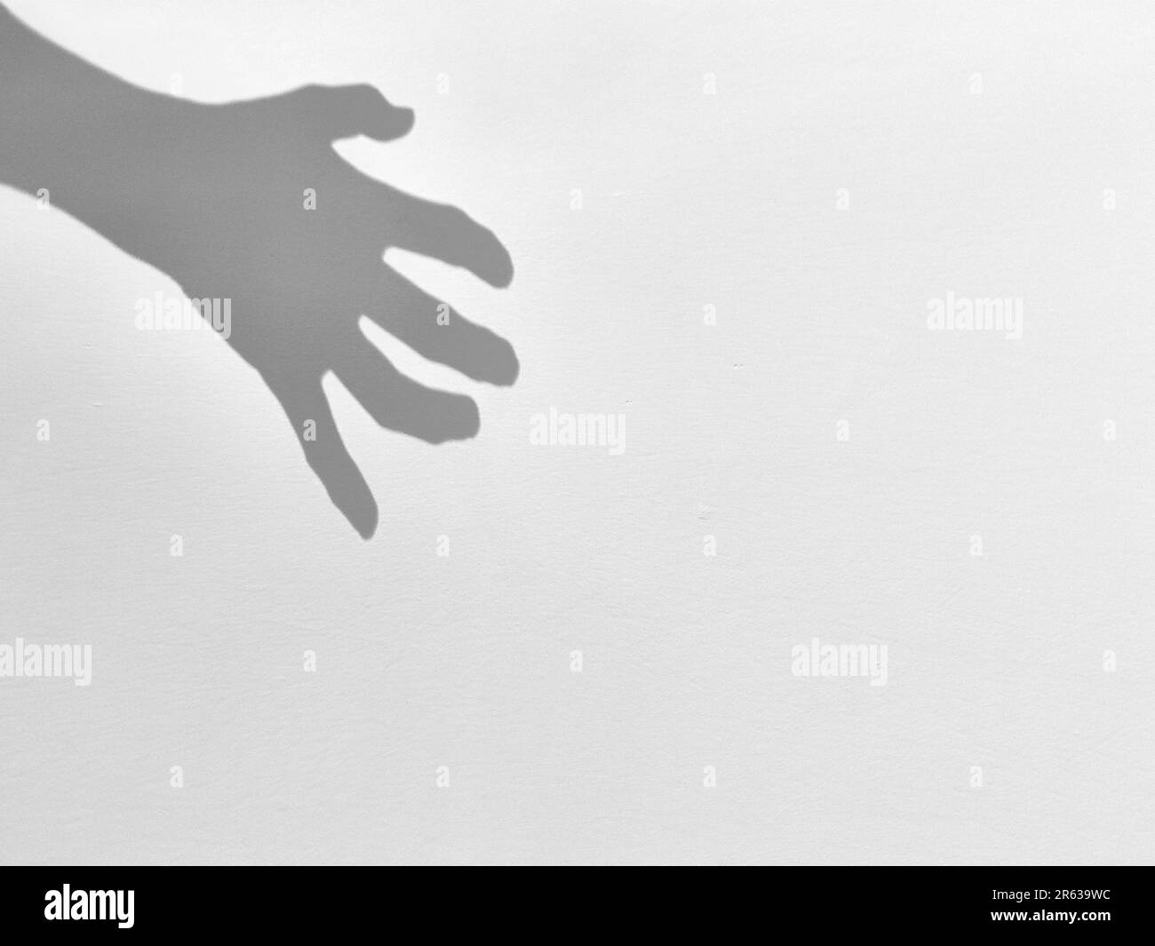 Shadow silhouette of creepy hand on gray wall, copy space, noise Stock ...