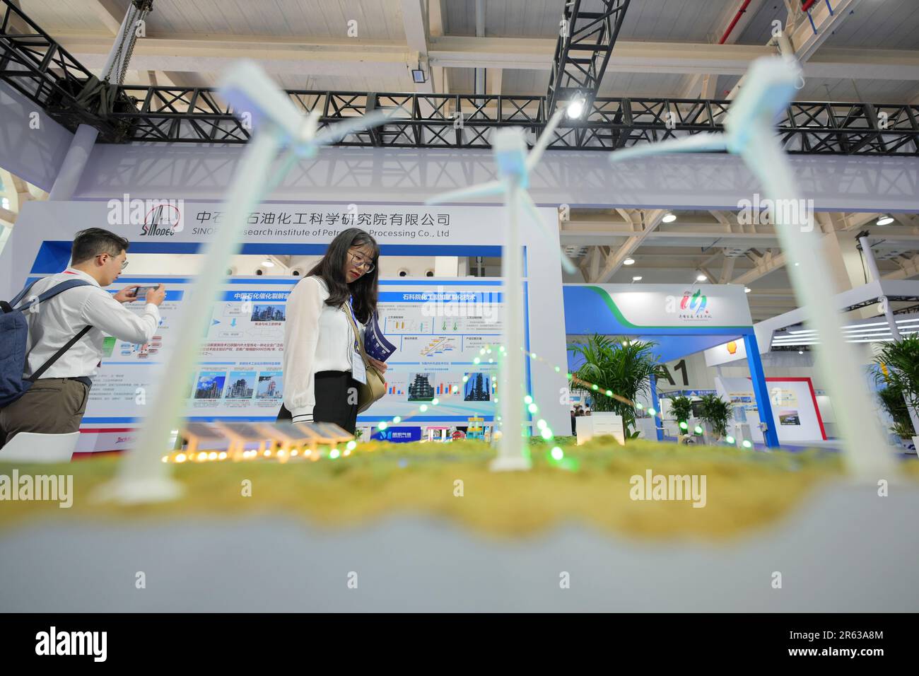 YANTAI, CHINA - JUNE 6, 2023 - Visitors look at a sand table model of a chemical production ...