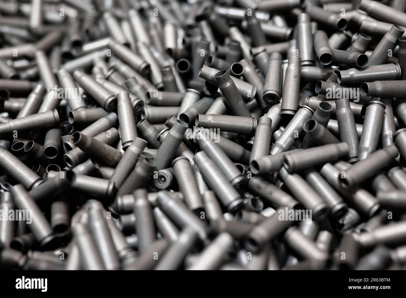 Bullet casings on dark background at armor production plant Stock Photo ...