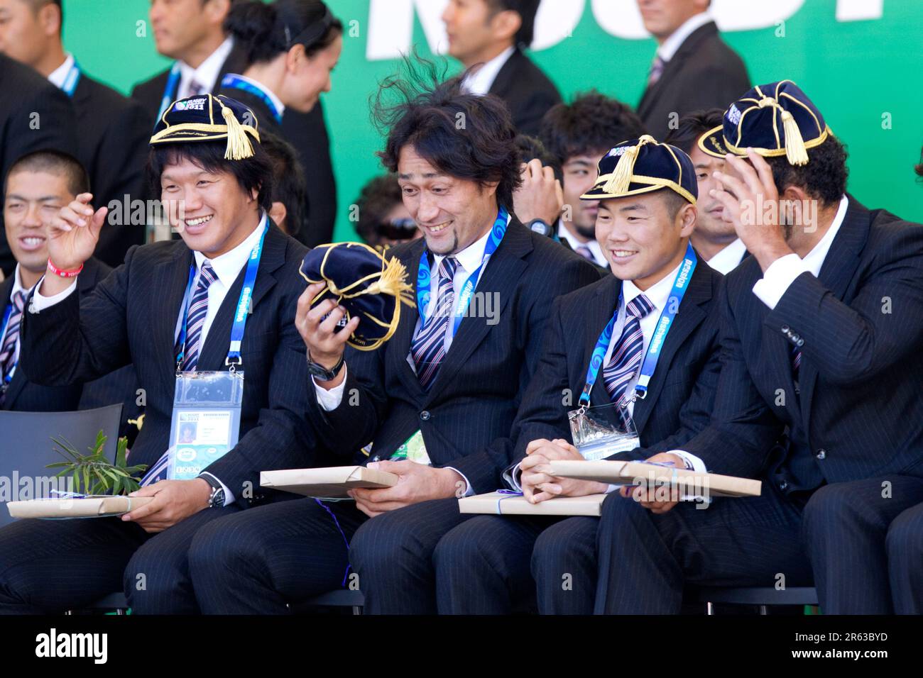 Hitoshi Ono, centre, inspects his tournament cap as members of the ...