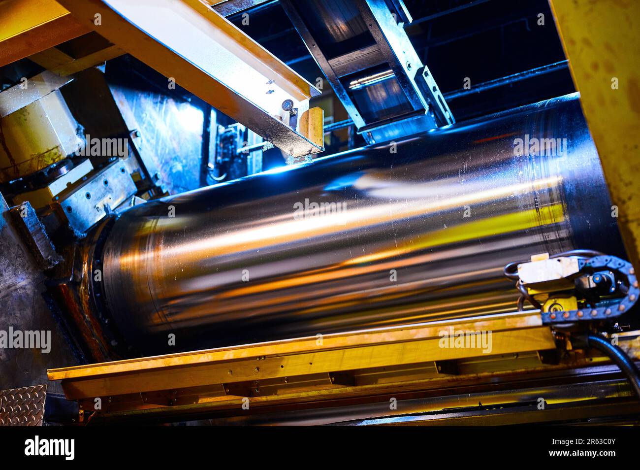 Shiny metal roller and steel cable processing in workshop Stock Photo ...