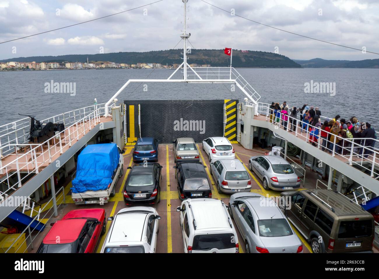 A ferry boat loaded with cars and passengers crosses the Dardanelles ...