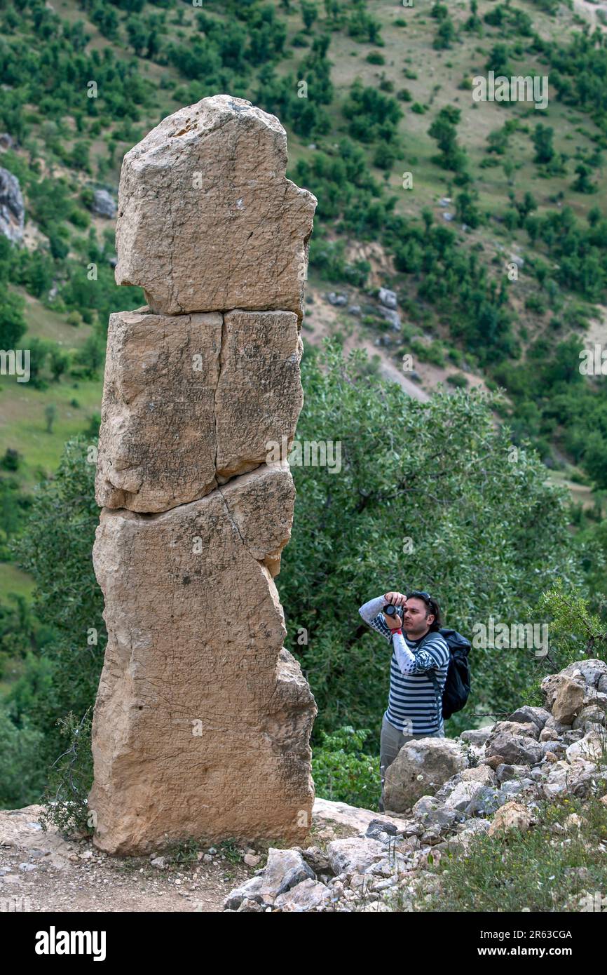 A man photographs the Mithras Relief at the Arsameia ruins (Arsameia on ...