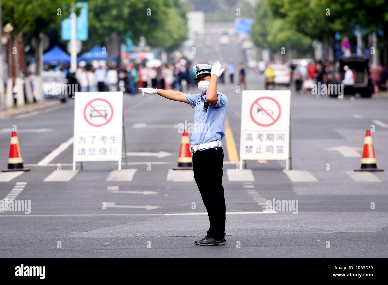 QINGDAO, CHINA - JUNE 7, 2023 - Traffic police direct traffic in front ...