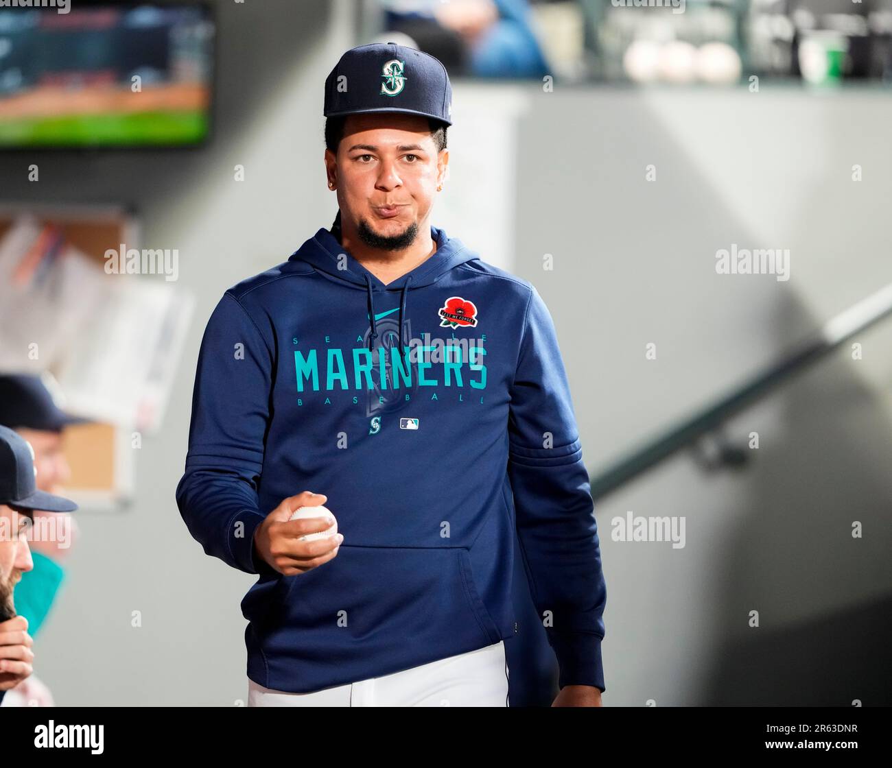 Seattle Mariners starting pitcher Luis Castillo walks in the dugout ...