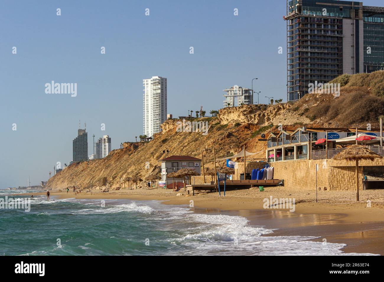 Skyscrapers tower above the Mediterranean Sea as it washes onto the ...