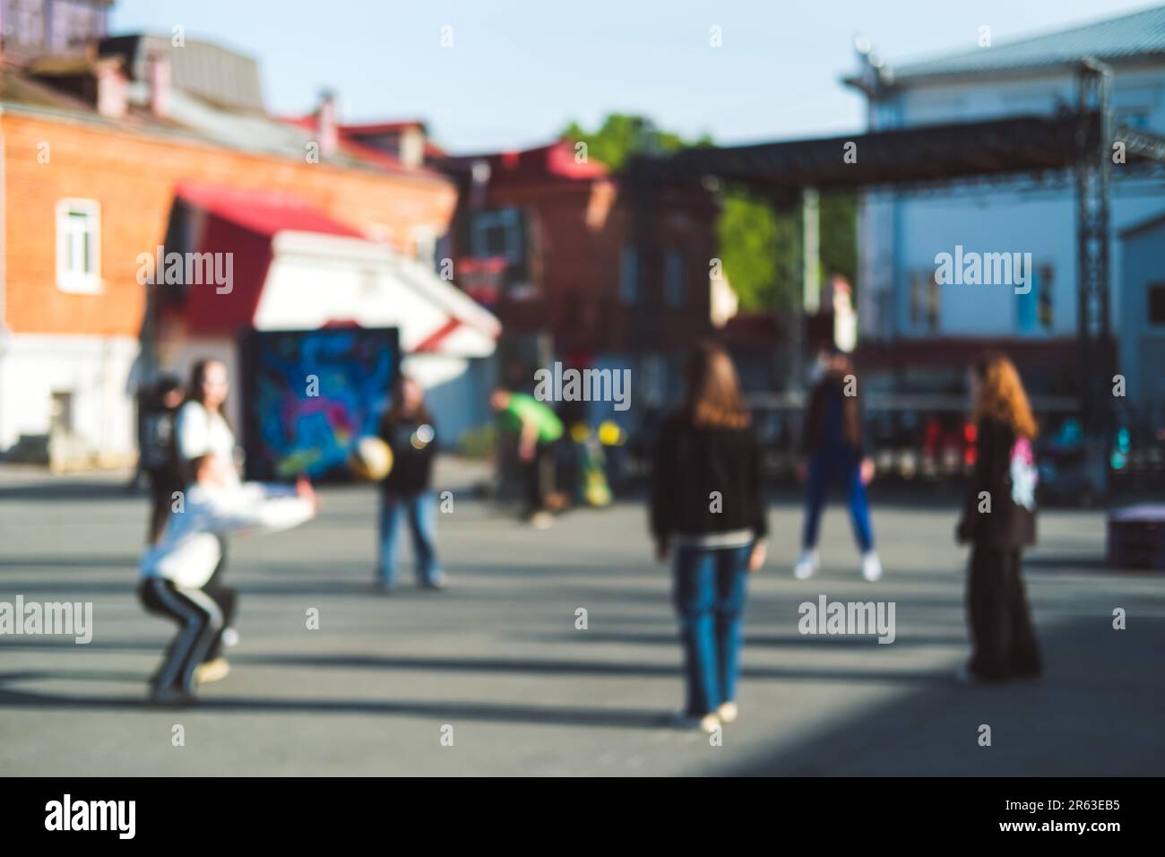 Blurred urban background with a group of people playing ball. A group ...