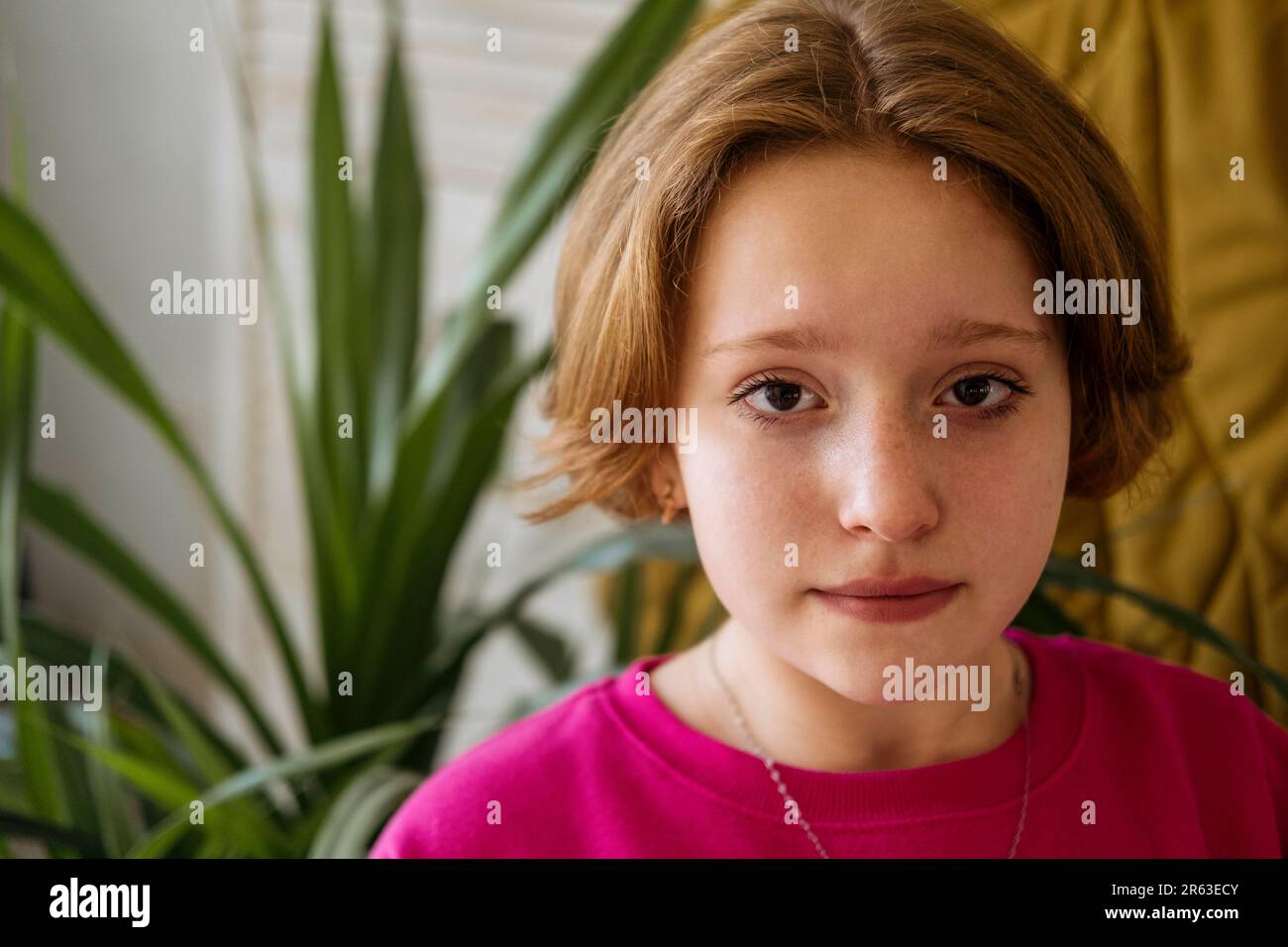 Red-haired teen girl, with freckles and black eyes, close-up portrait ...