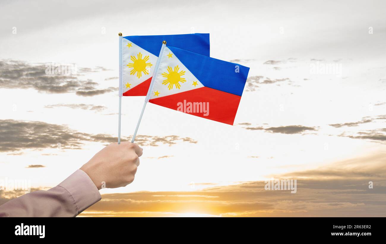 A human hand holding a Philippine flag. Philippines Independence Day ...