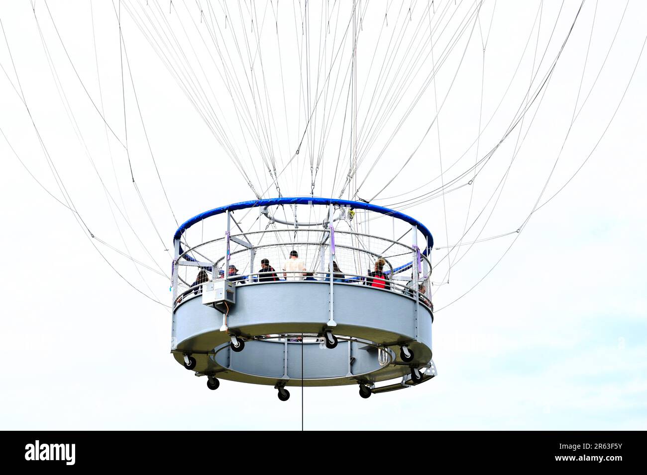 round metal observation stage and cage levitating, hanging from gas ...