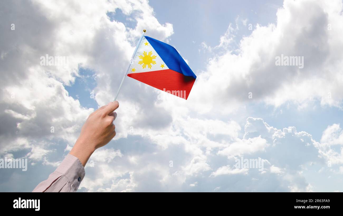 A human hand holding a Philippine flag. Philippines Independence Day ...