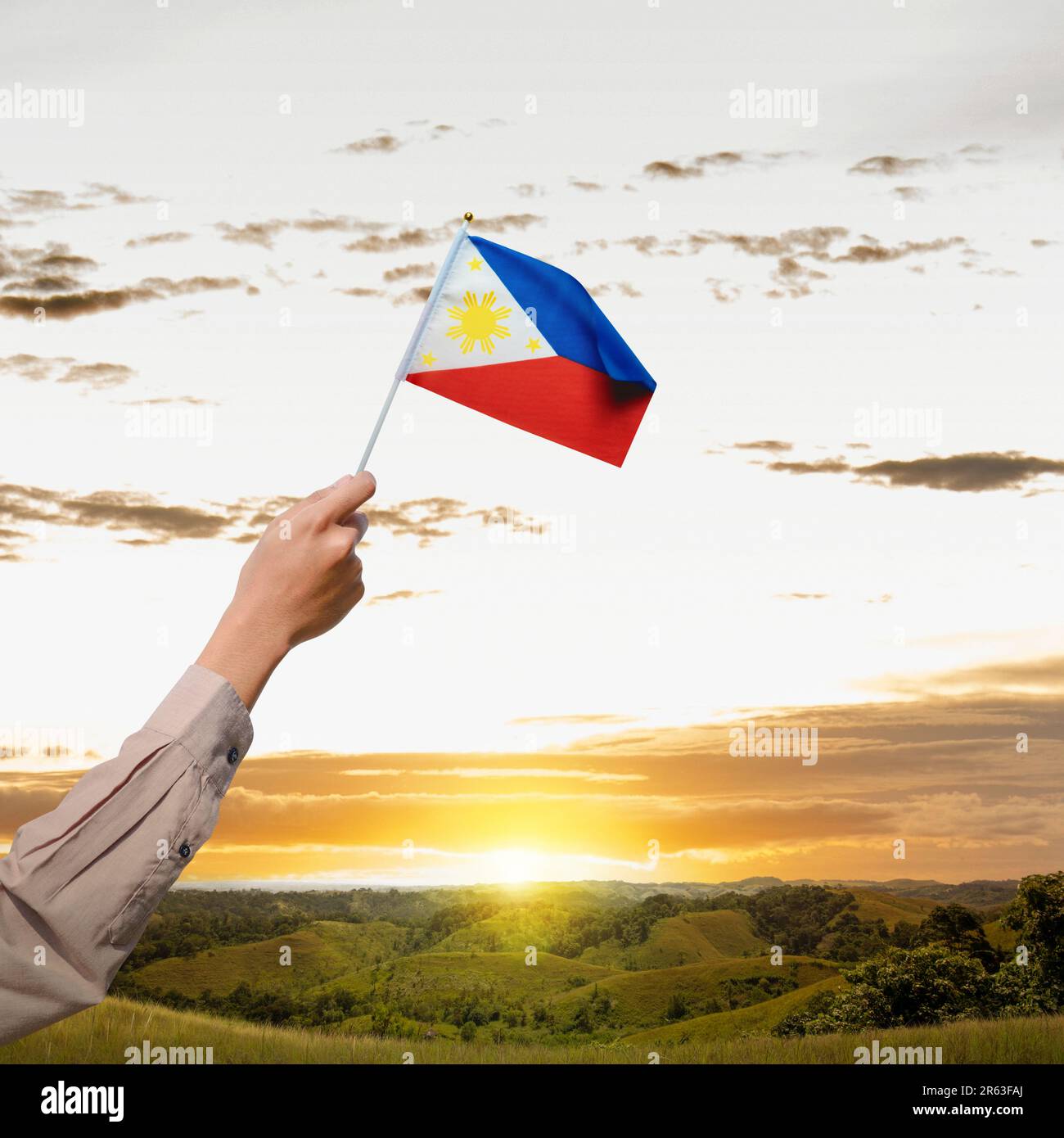 A human hand holding a Philippine flag. Philippines Independence Day ...