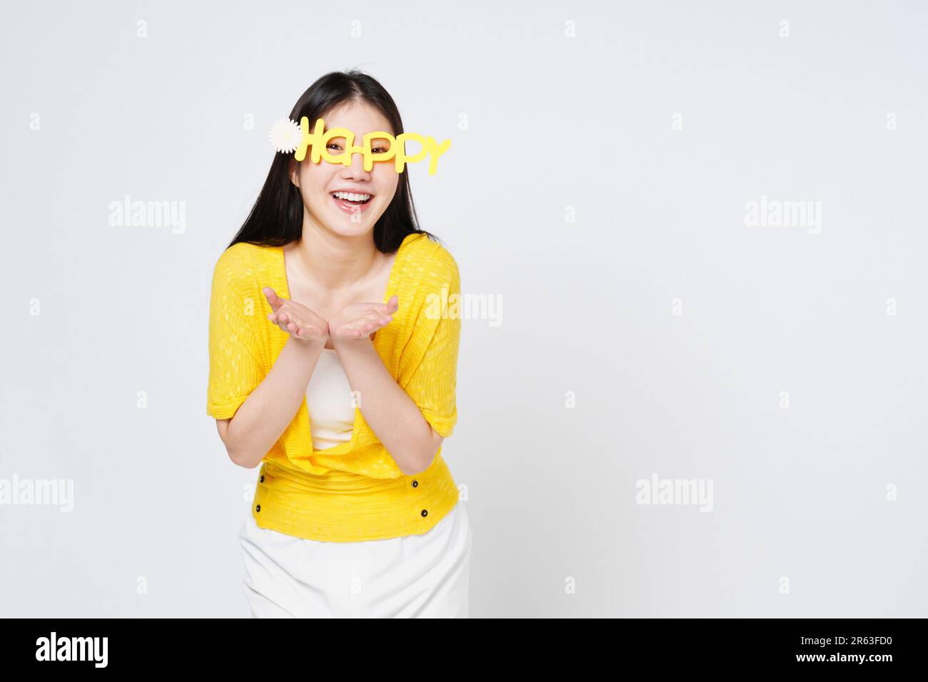 Happy young woman presenting or showing open hand palm with copy space ...