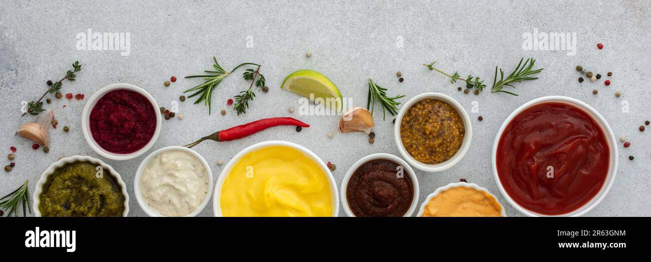 Different types of sauces in bowls with seasonings banner, rosemary and ...