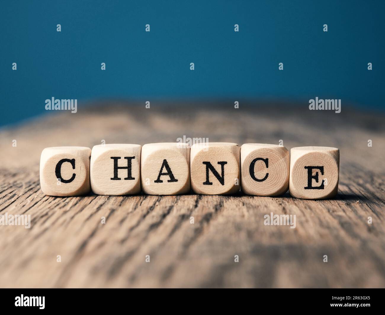 Small wooden dices with the word Chance on an office table Stock Photo ...