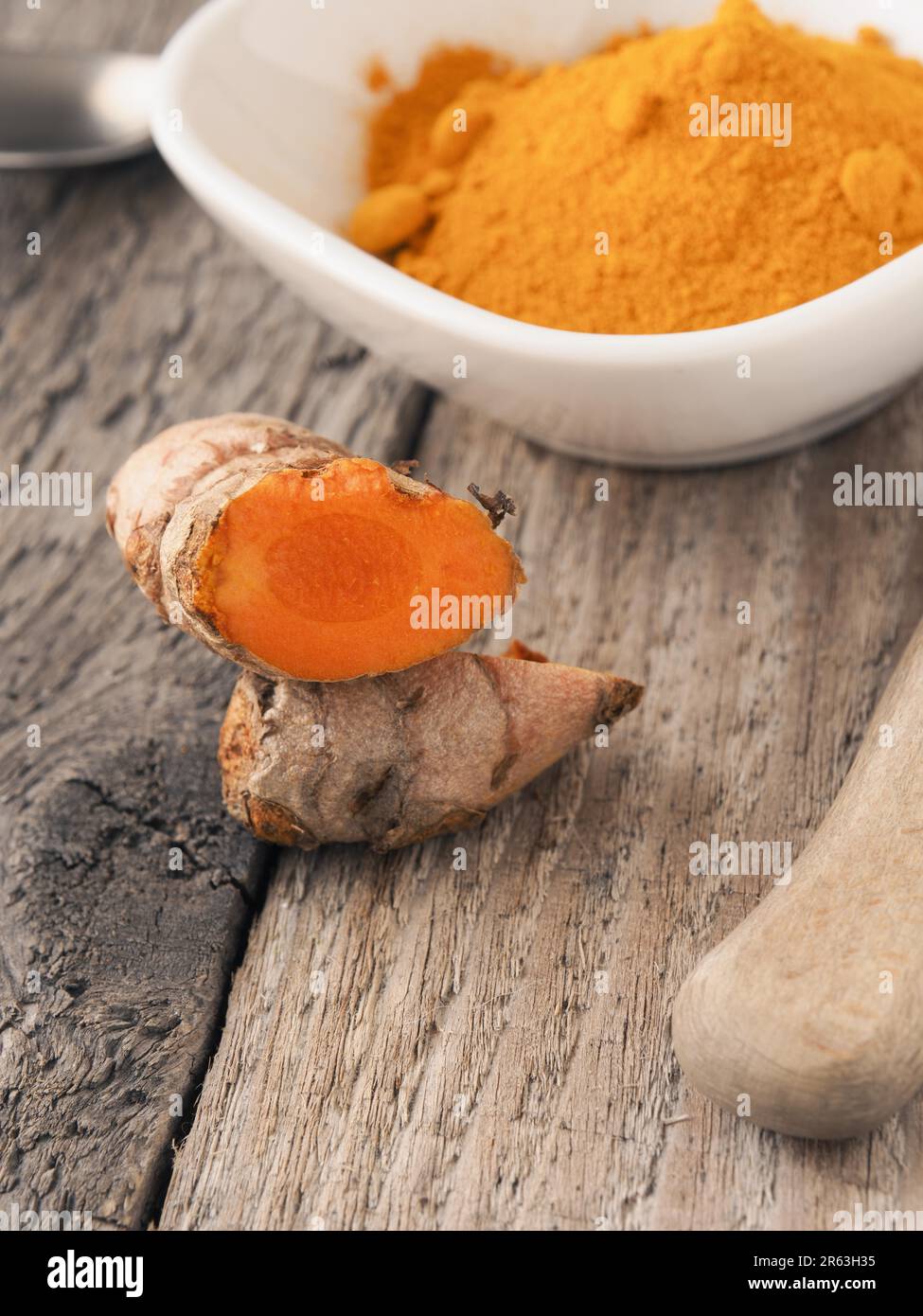 Turmeric rhizome and powder on a rustic wooden table, view from above ...