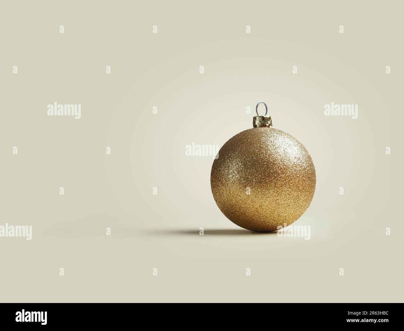 Christmas background with a single golden Christmas bauble on a bright ...