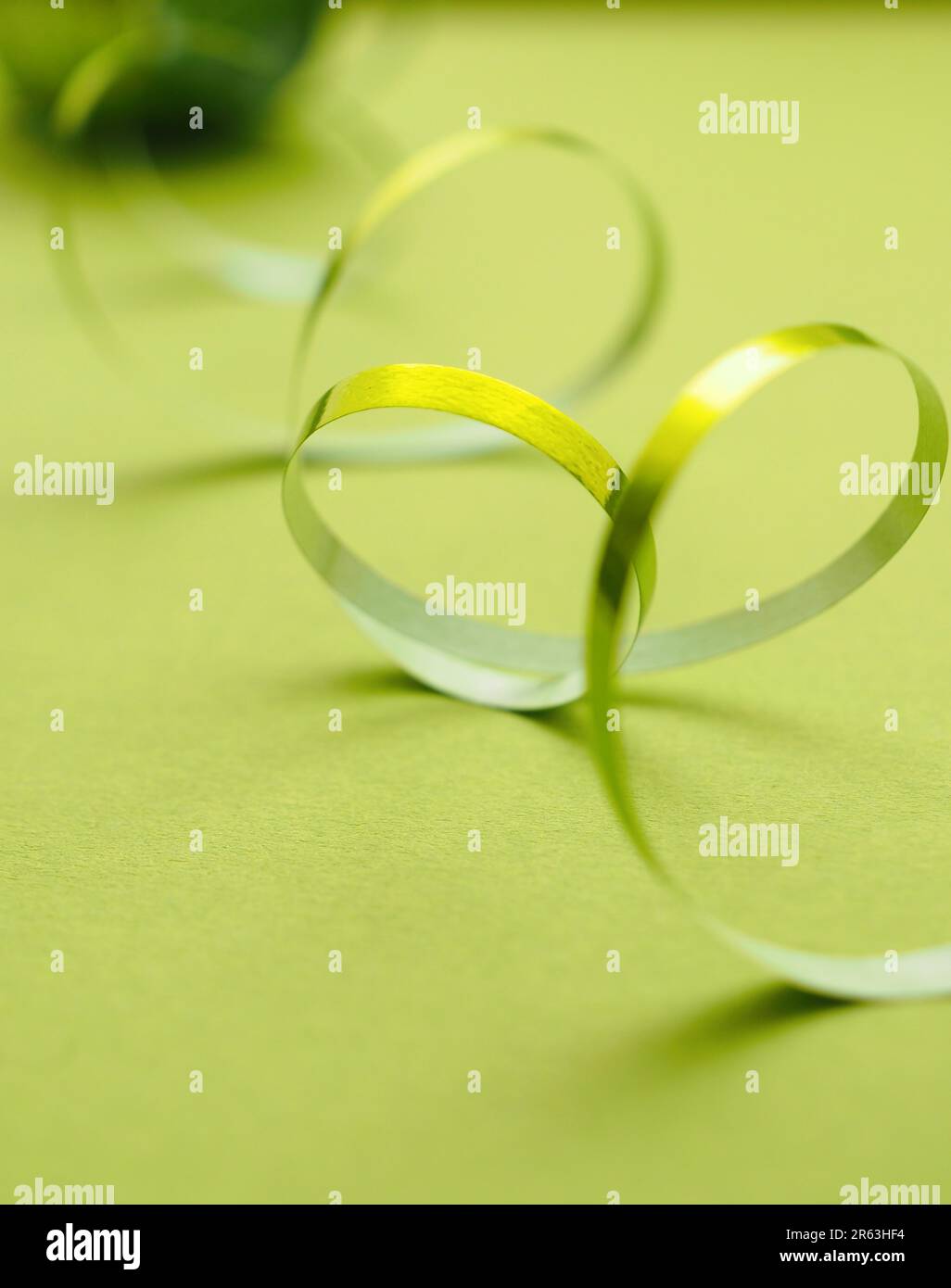 Shiny green ribbon on a green background, Christmas decoration ...