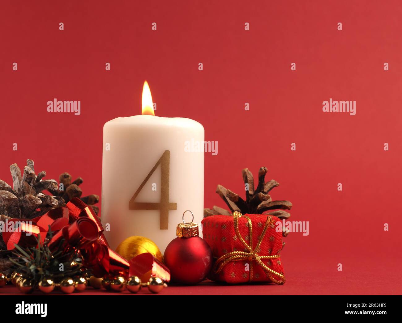 Fourth Advent candle burns, white candle with the number four on a red ...