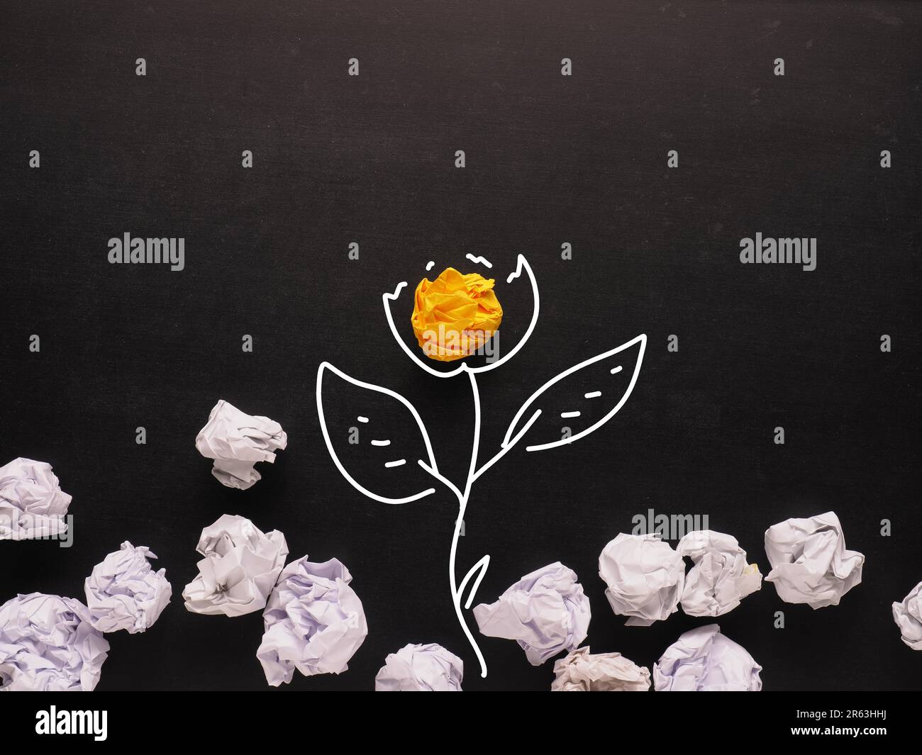 Concept for new ideas, yellow crumpled paper grows up as a flower ...