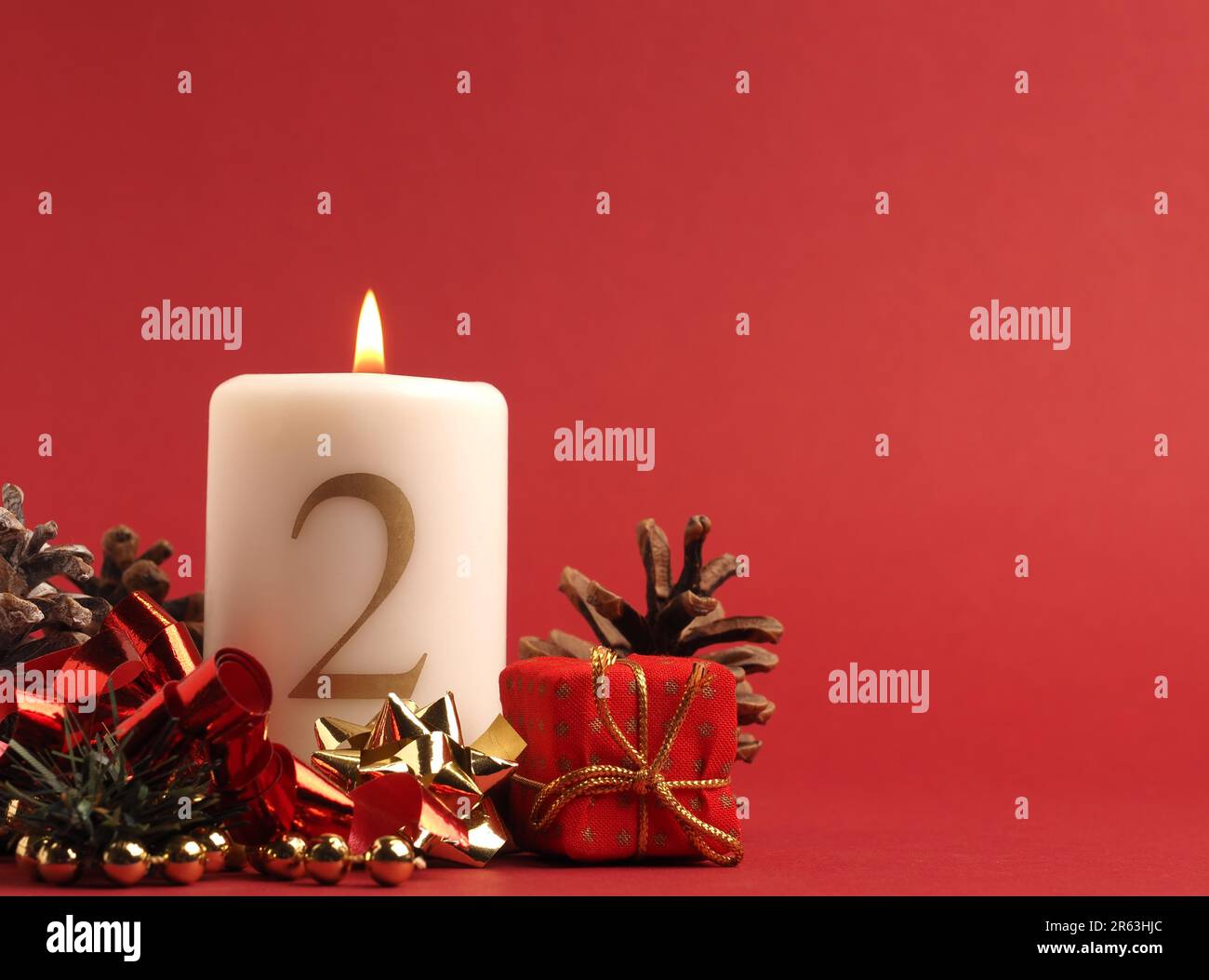 Second Advent candle burns, white candle with the number two on a red ...