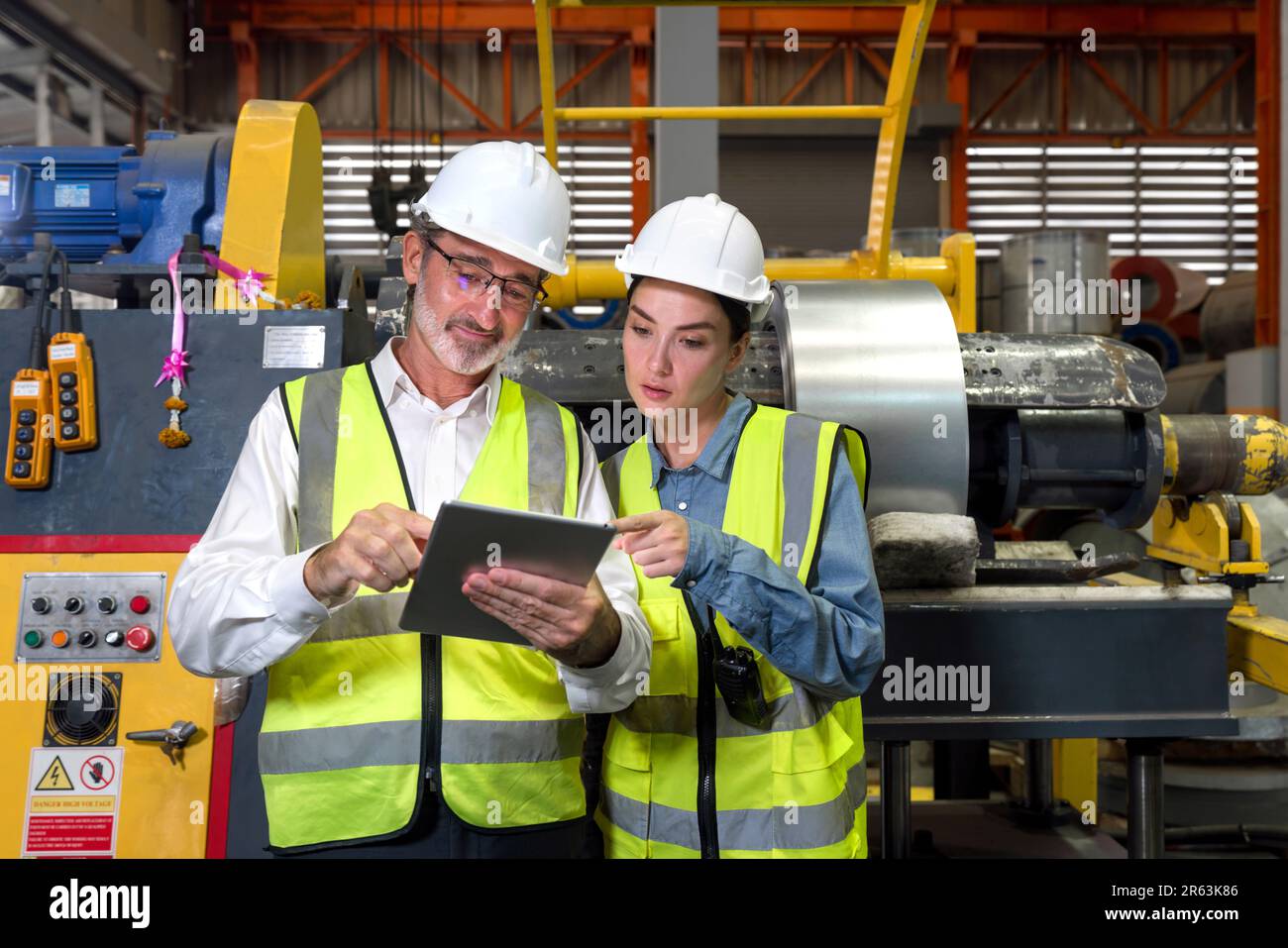 Senior engineer manager trains new employees within the metal sheet ...