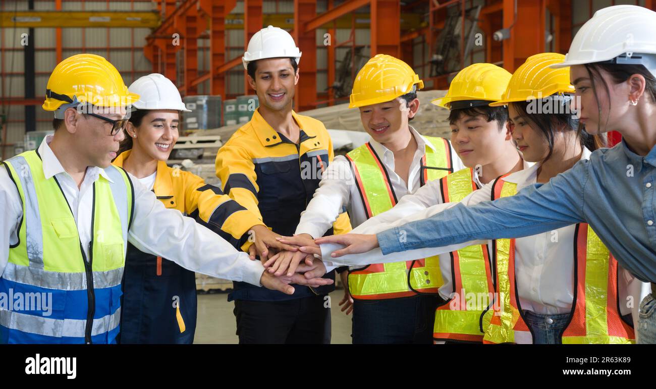 Group of male and female factory labor join hands together after finish ...