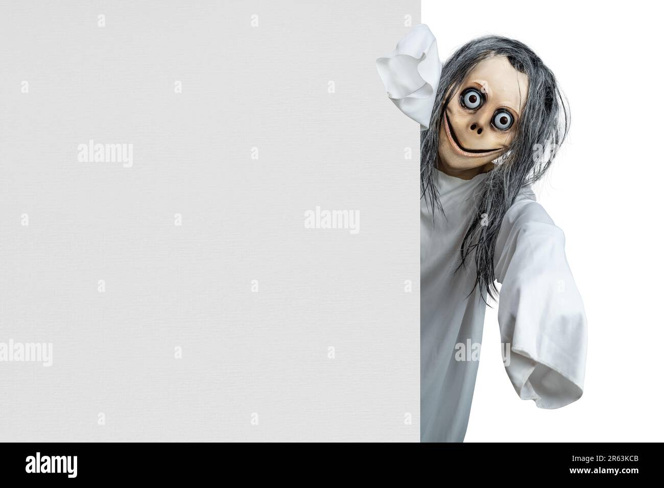 Scary Momo standing behind the wall on white background. Scary face for ...