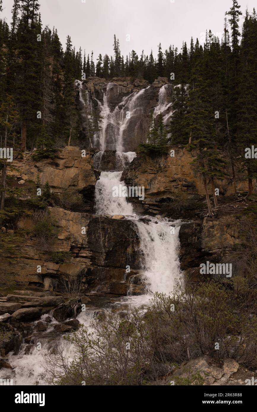 A spectacular waterfall cascading down the side of a majestic mountain ...