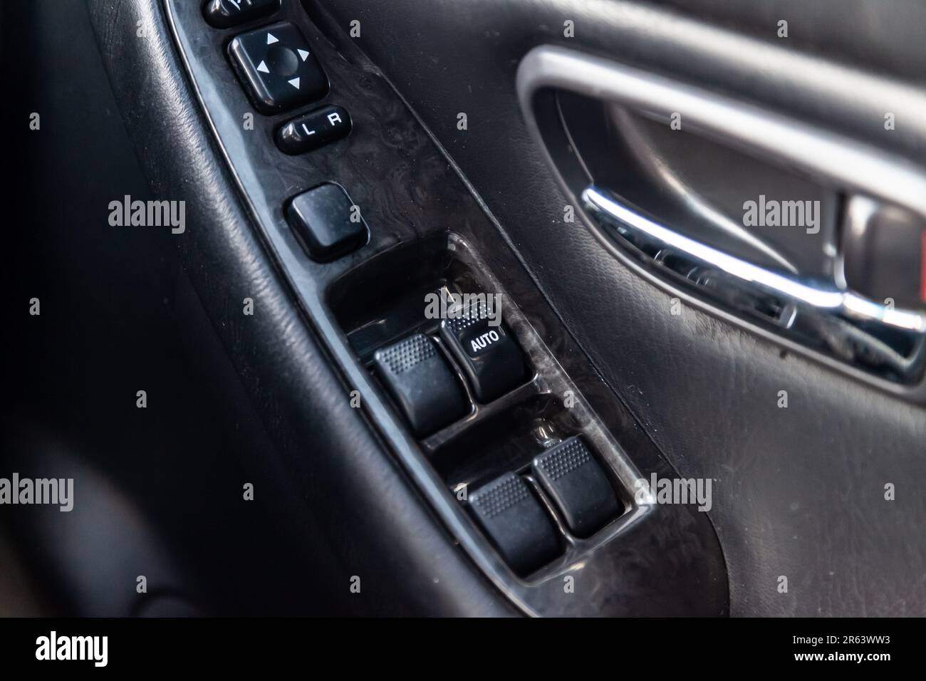 Close-up of the side door buttons: window adjustment buttons, door lock ...