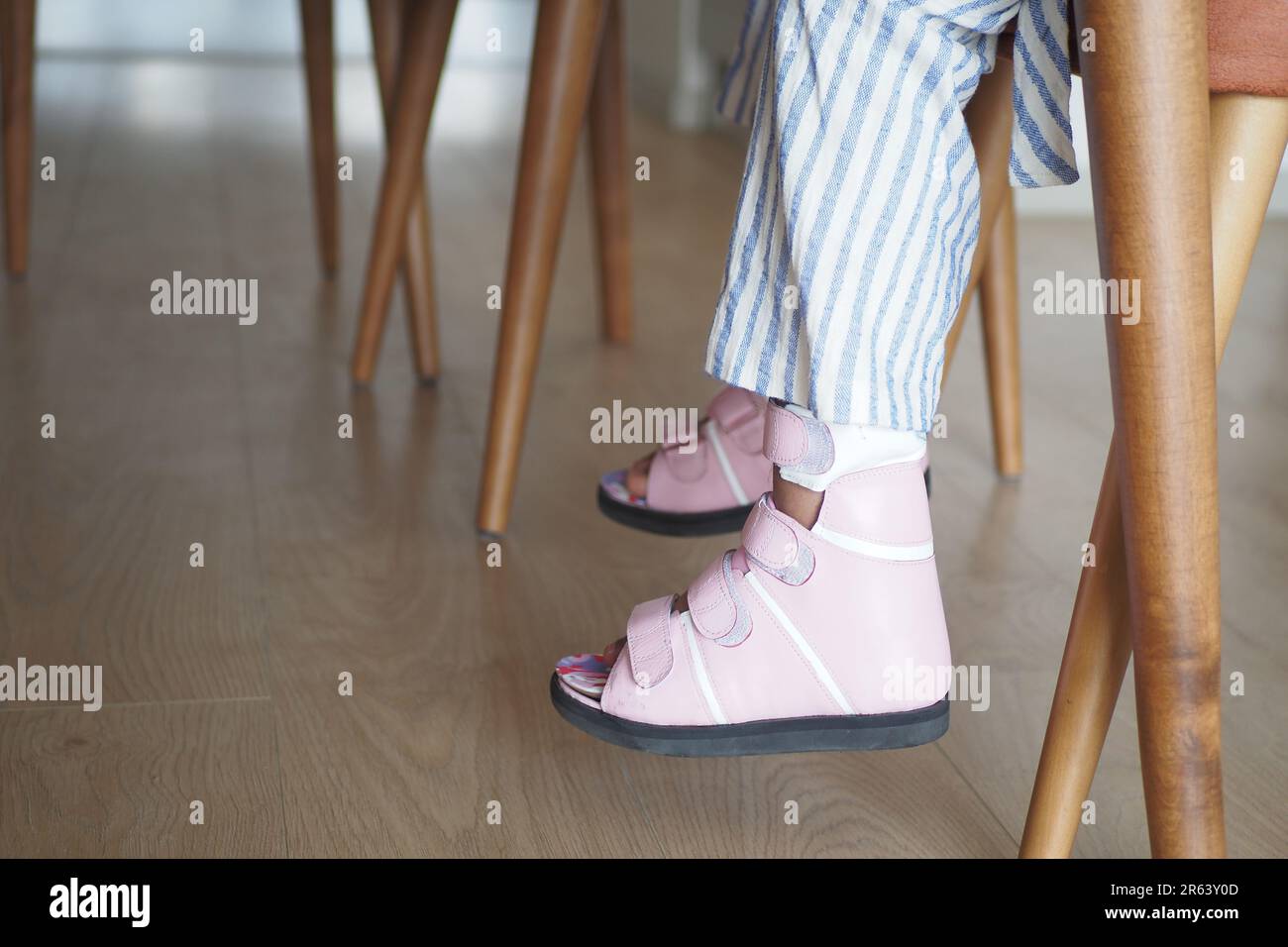 Child cerebral palsy disability, legs orthosis Stock Photo - Alamy