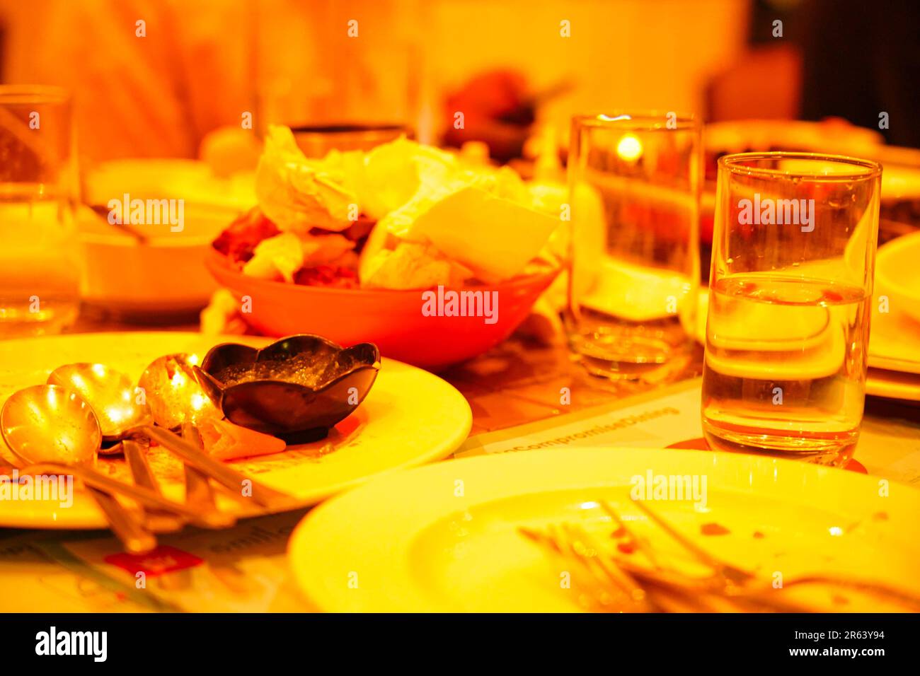 A dining table after a dinner in warm light, close up shots Stock Photo ...