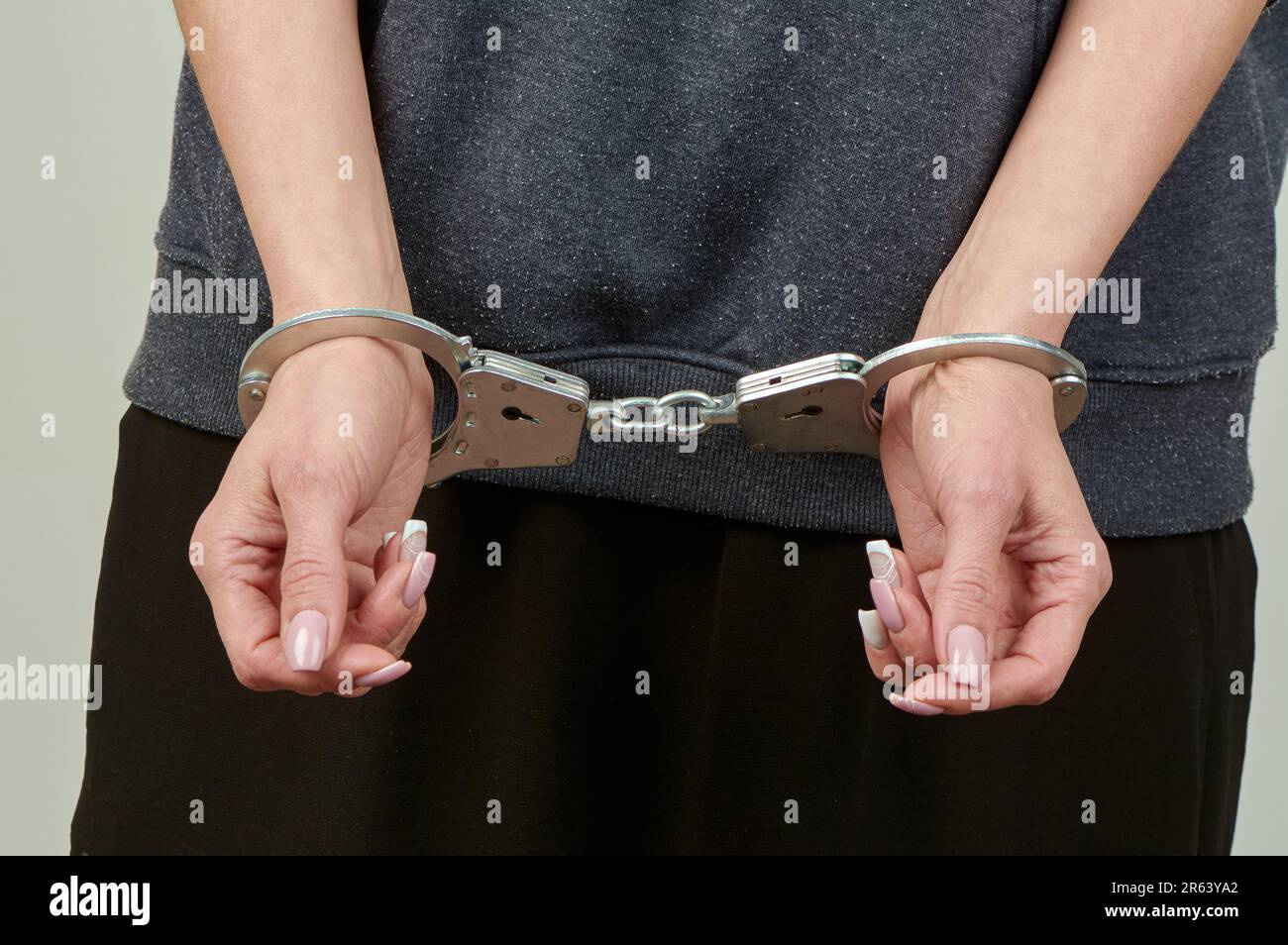 women's hands are handcuffed in close-up Stock Photo - Alamy