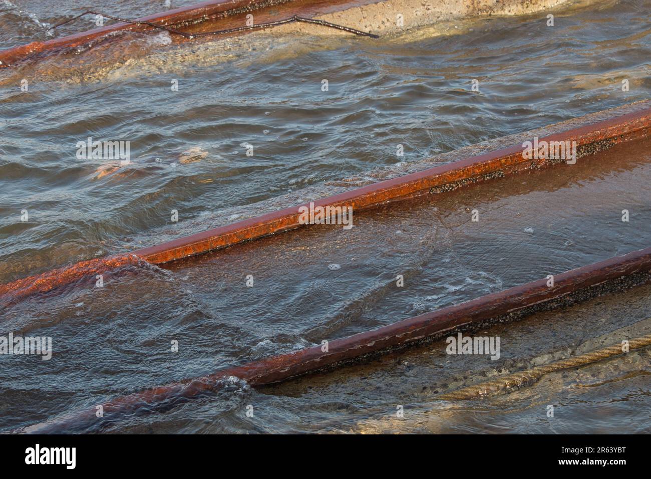 Submerged rails in sea on dry dock slipway Stock Photo - Alamy
