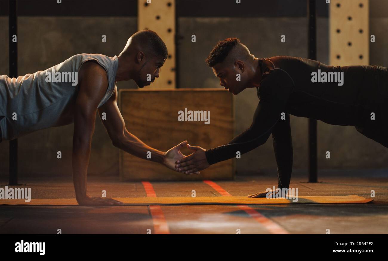 High five, fitness and men with floor push up at a gym for support ...