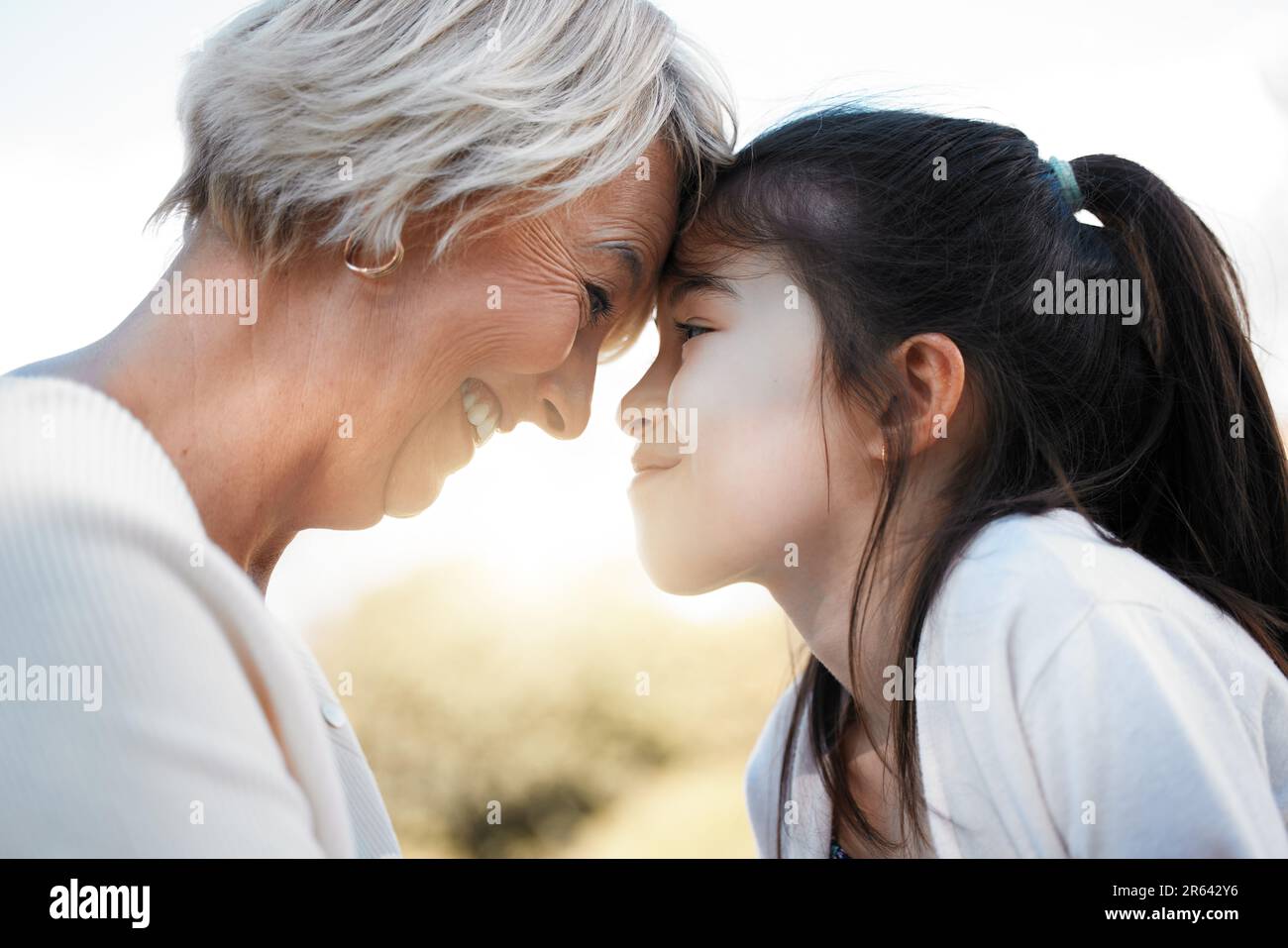 Grandmother, girl and close with happiness in nature with love in ...