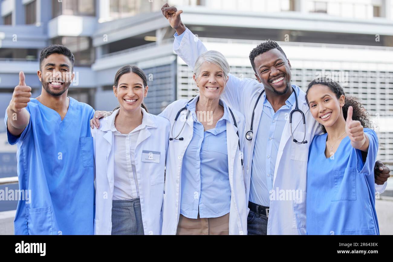Doctor team, city and thumbs up with hug and celebration for healthcare ...