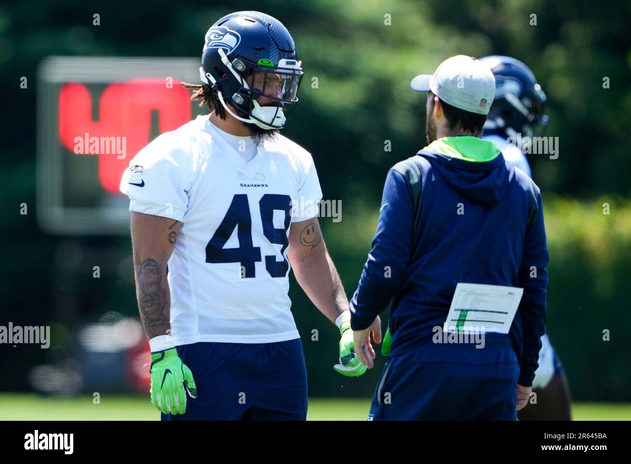 Seattle Seahawks linebacker Joshua Onujiogu talks with a member of the ...