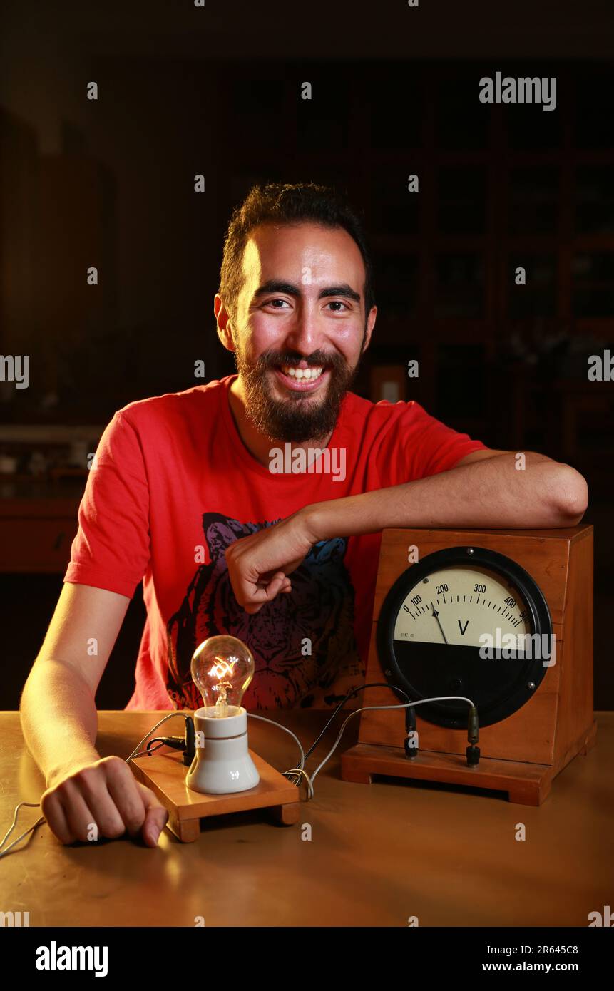 Bearded caucasian electric man posing with an electric bulb and vintage ...
