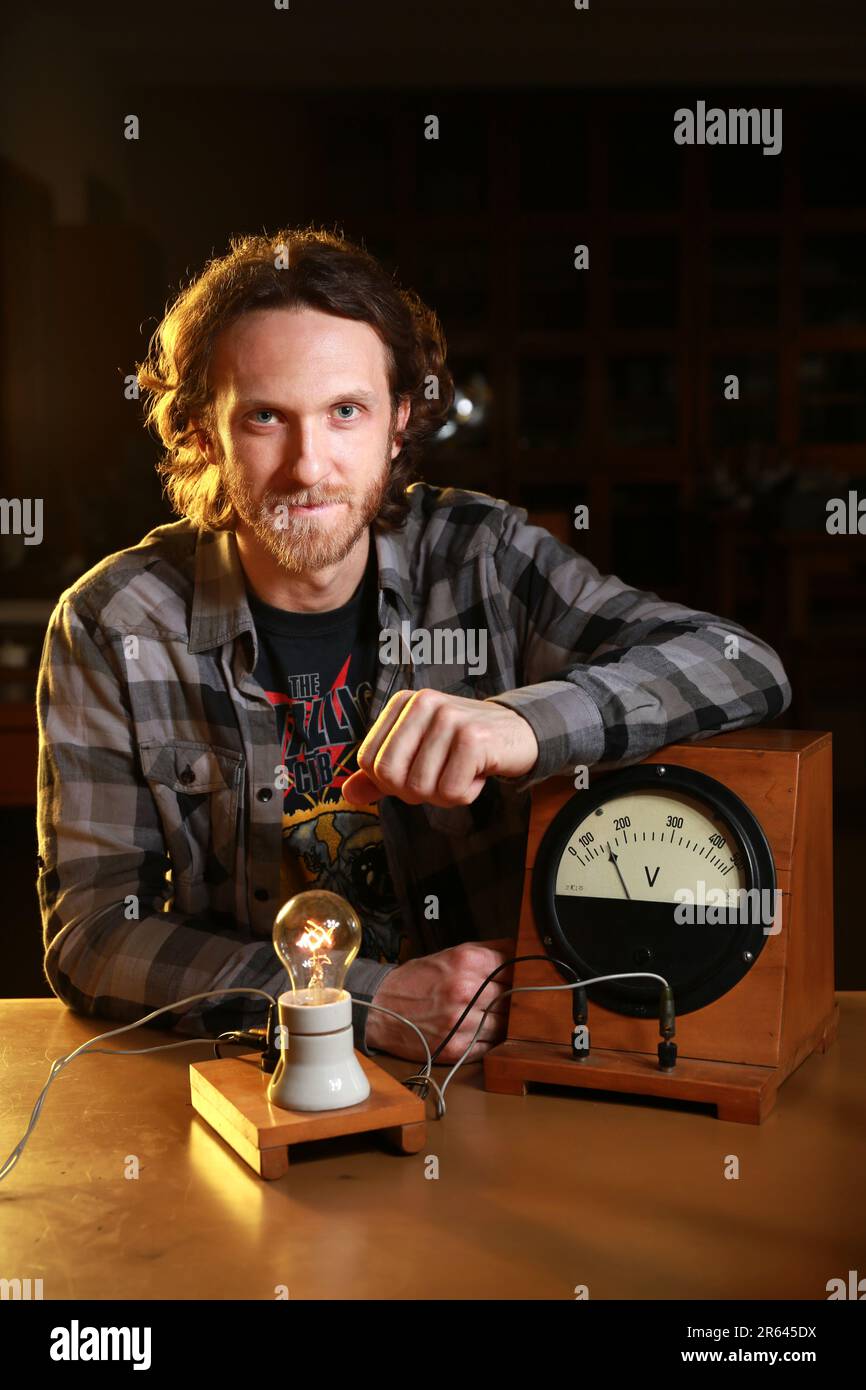 Bearded caucasian electric man posing with an electric bulb and vintage ...