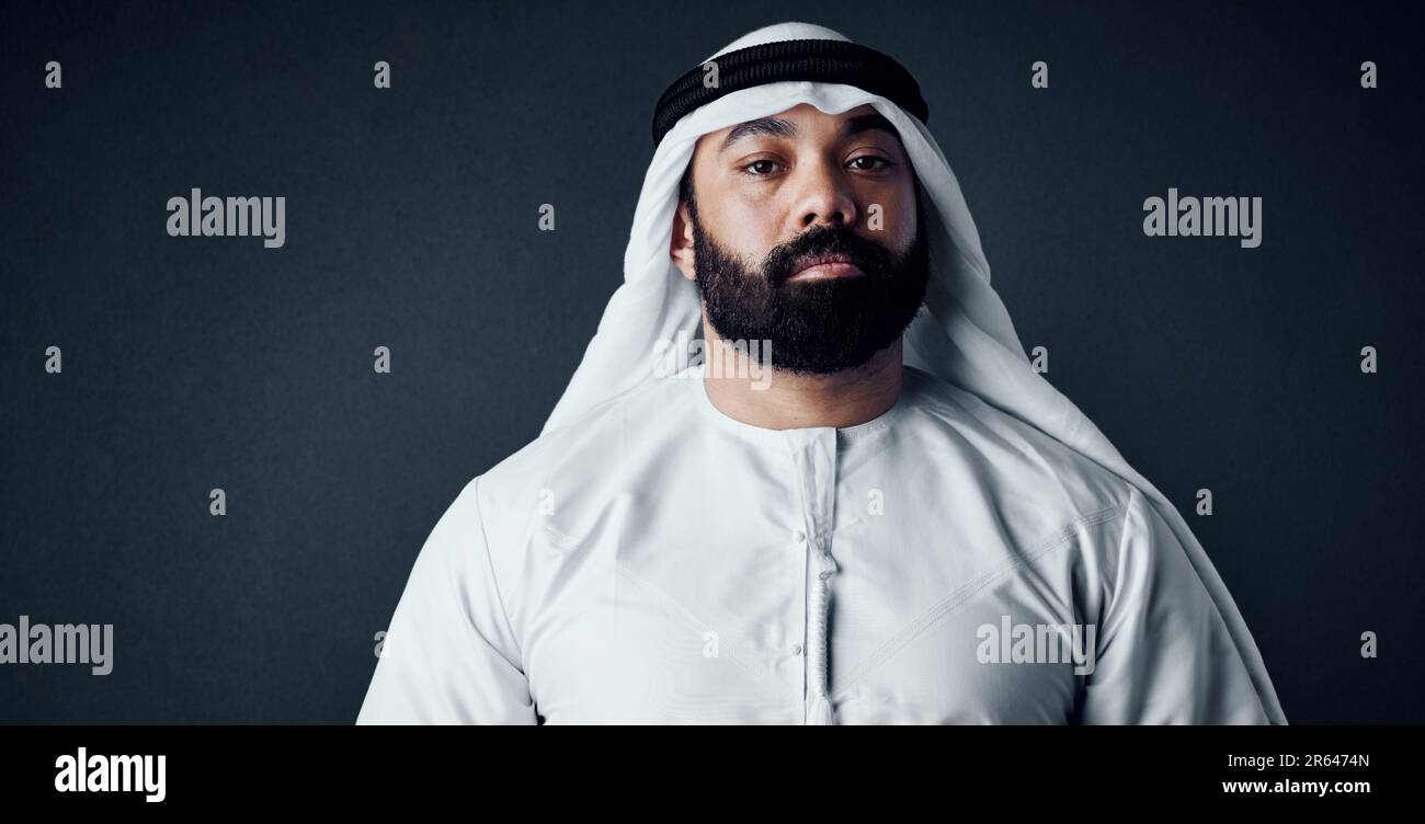 Strong and independent. Studio shot of a young man dressed in Islamic ...