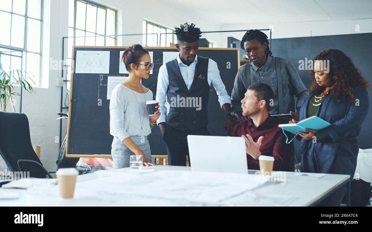 Getting his teams input. a group of creative businesspeople meeting in ...