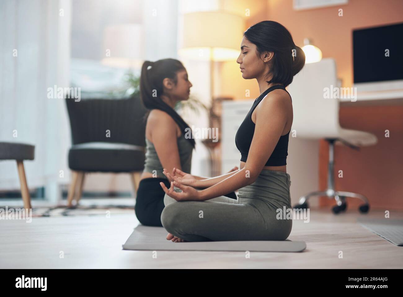 Friends, meditation and women exercise together in a house with ...