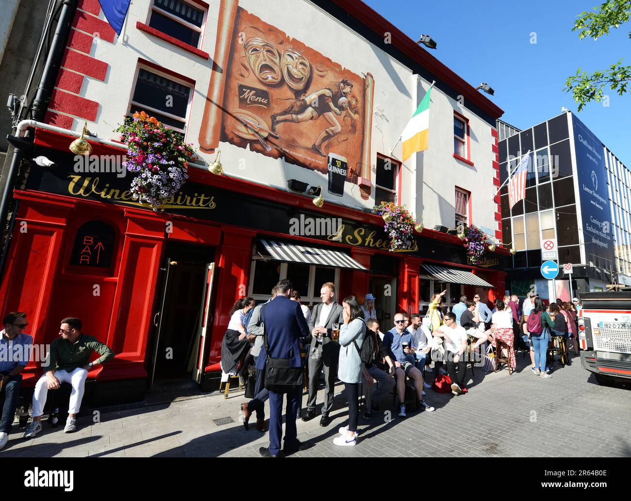 Irish crowed socializing and drinking beers outside Sheehans Pub on ...