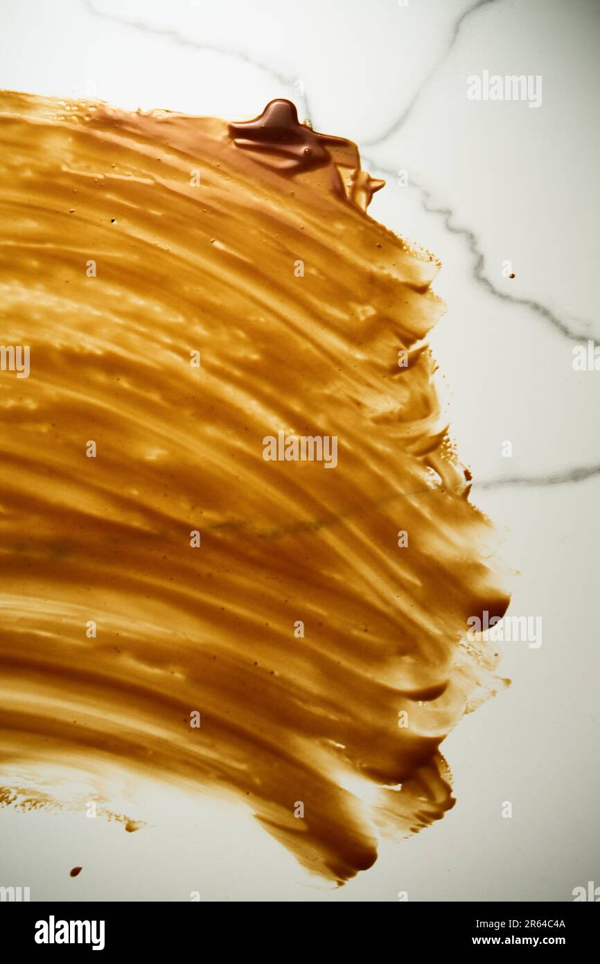 Salted Caramel sauce smeared on the tabletop. A tabletop stained with ...