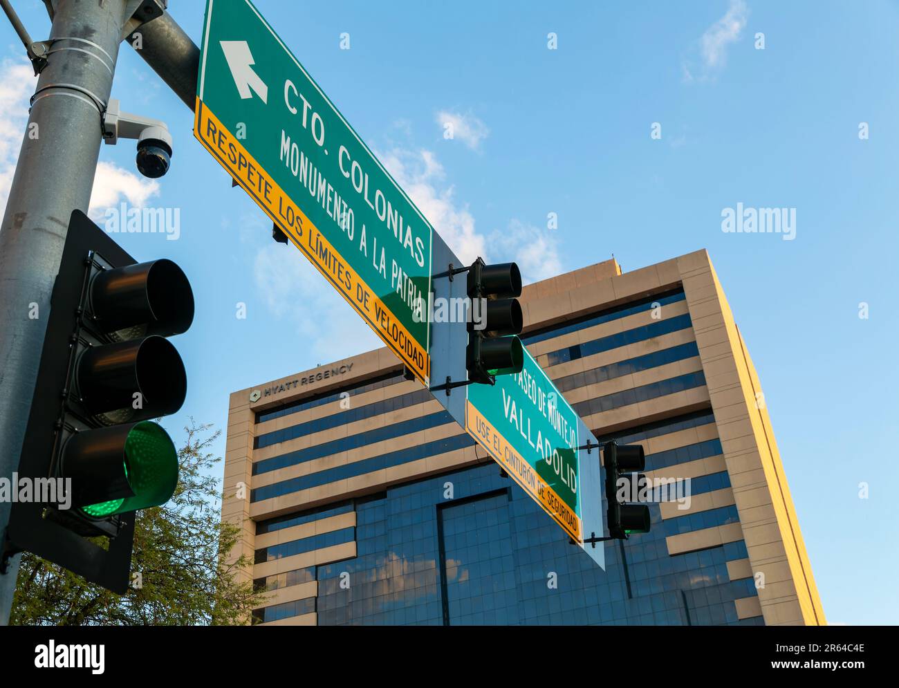 Looking up at traffic lights with green light to Hyatt Regency hotel ...