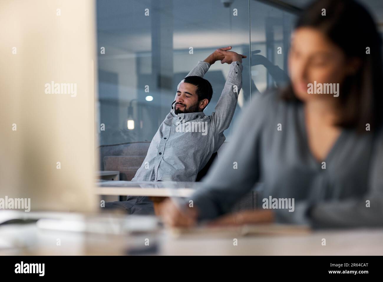 Call center, tired man and stretching at computer desk for ...