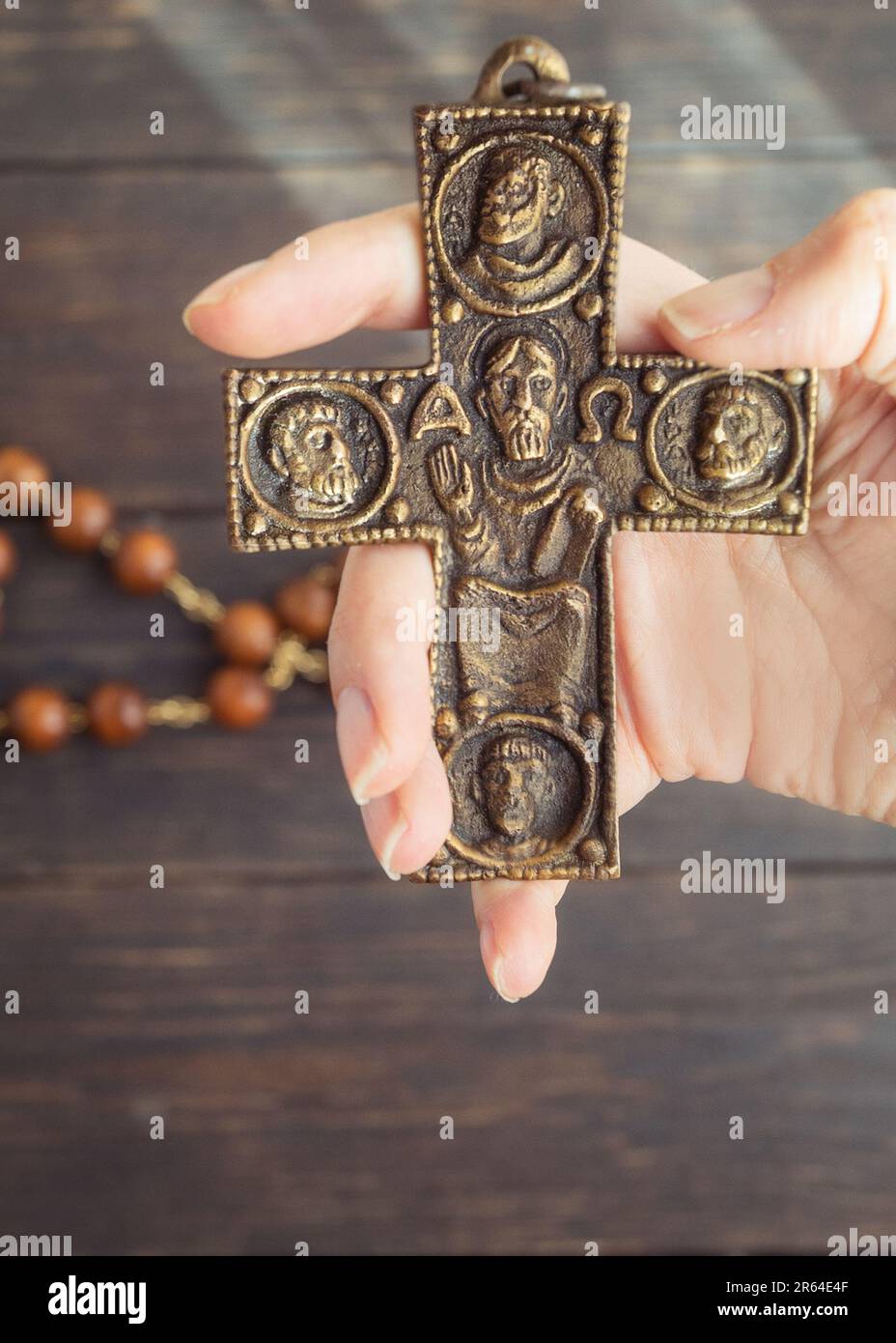 Hand holding cross, symbol of symbol of Christianity with light from ...