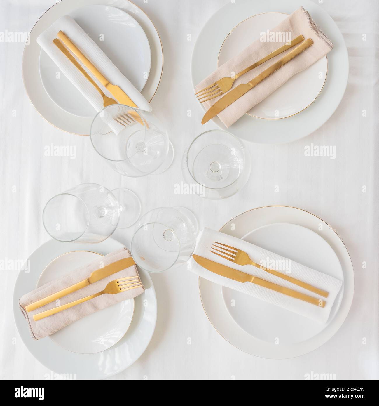 Top view of tableware with linen napkins, gold cutlery and white ...